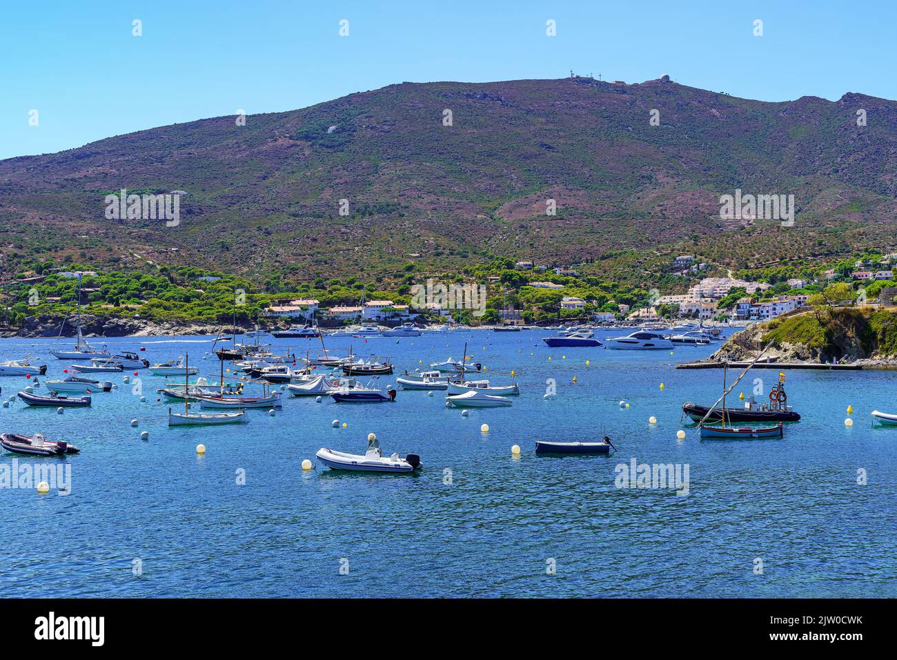 Small boats docked in the bay of Cadaques on the Costa Brava, Catalonia ...