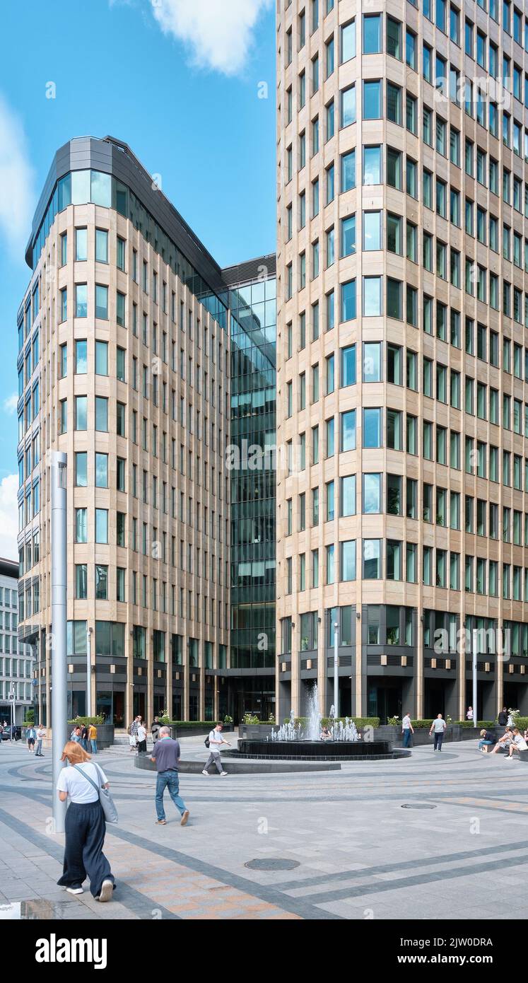 View of pedestrians and fountain in front of the modern business center ...