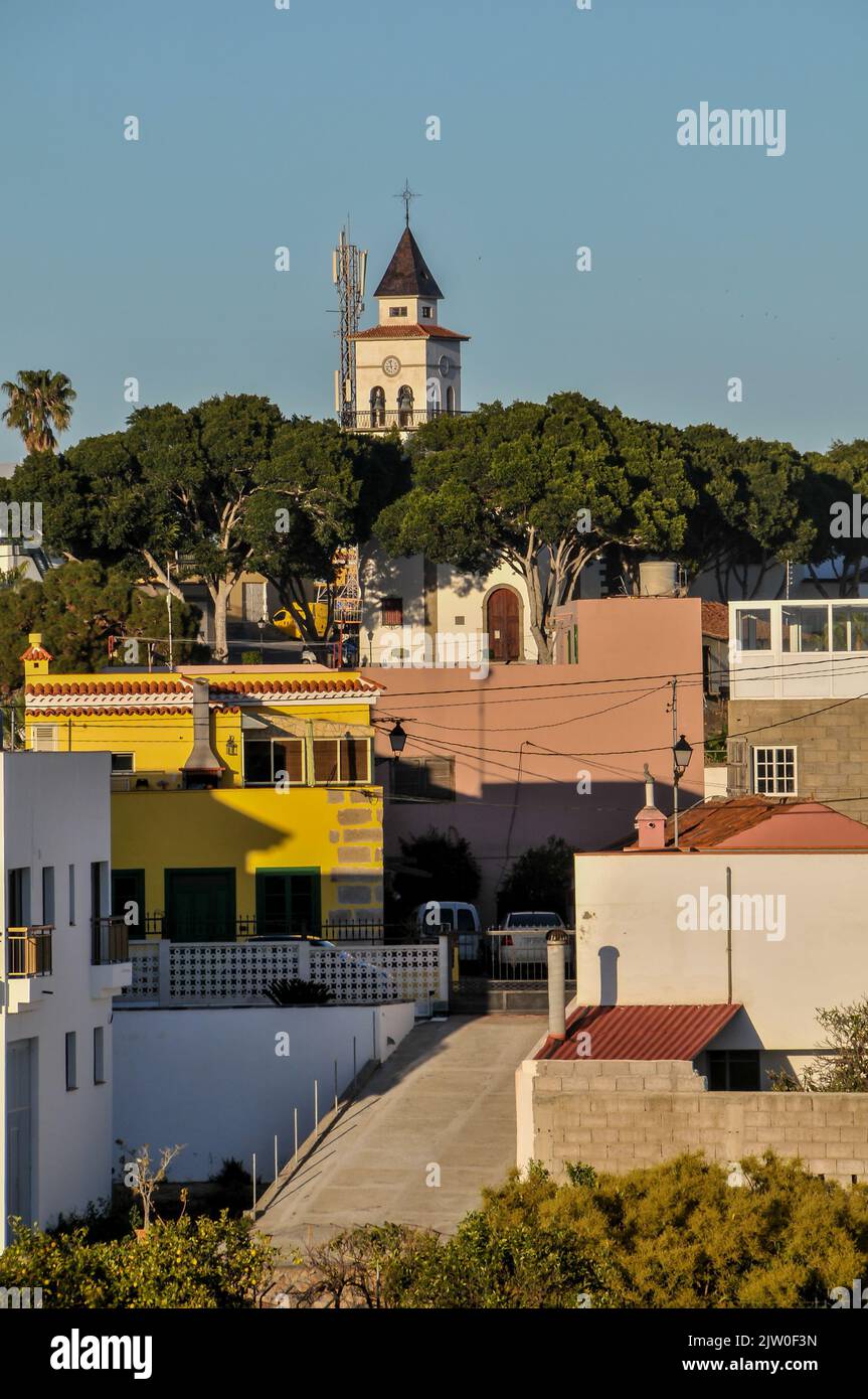 A vertical shot of colonial buildings on an island with a chapel in the ...