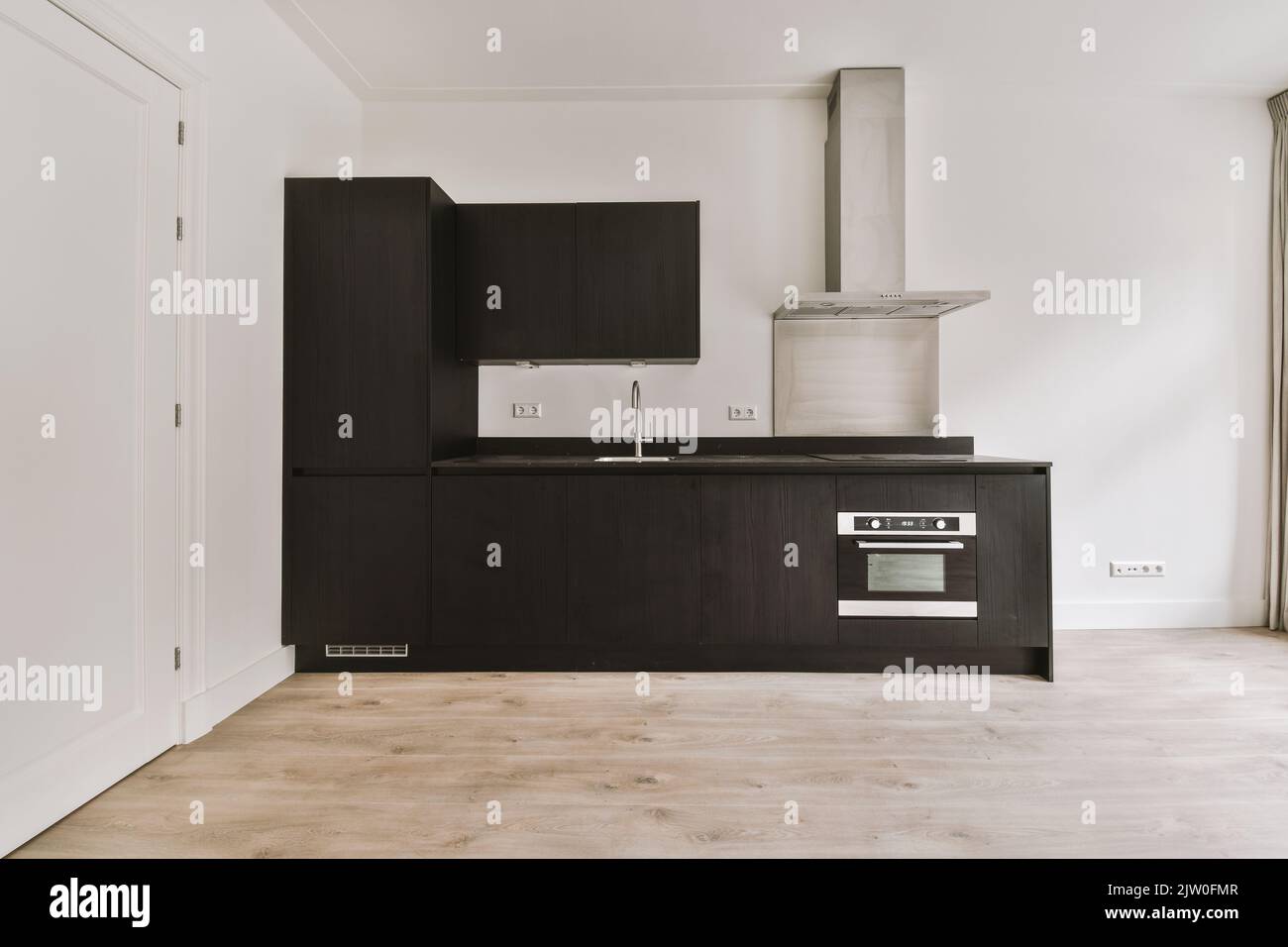 Interior of empty white kitchen with windows and wooden parquet floor ...