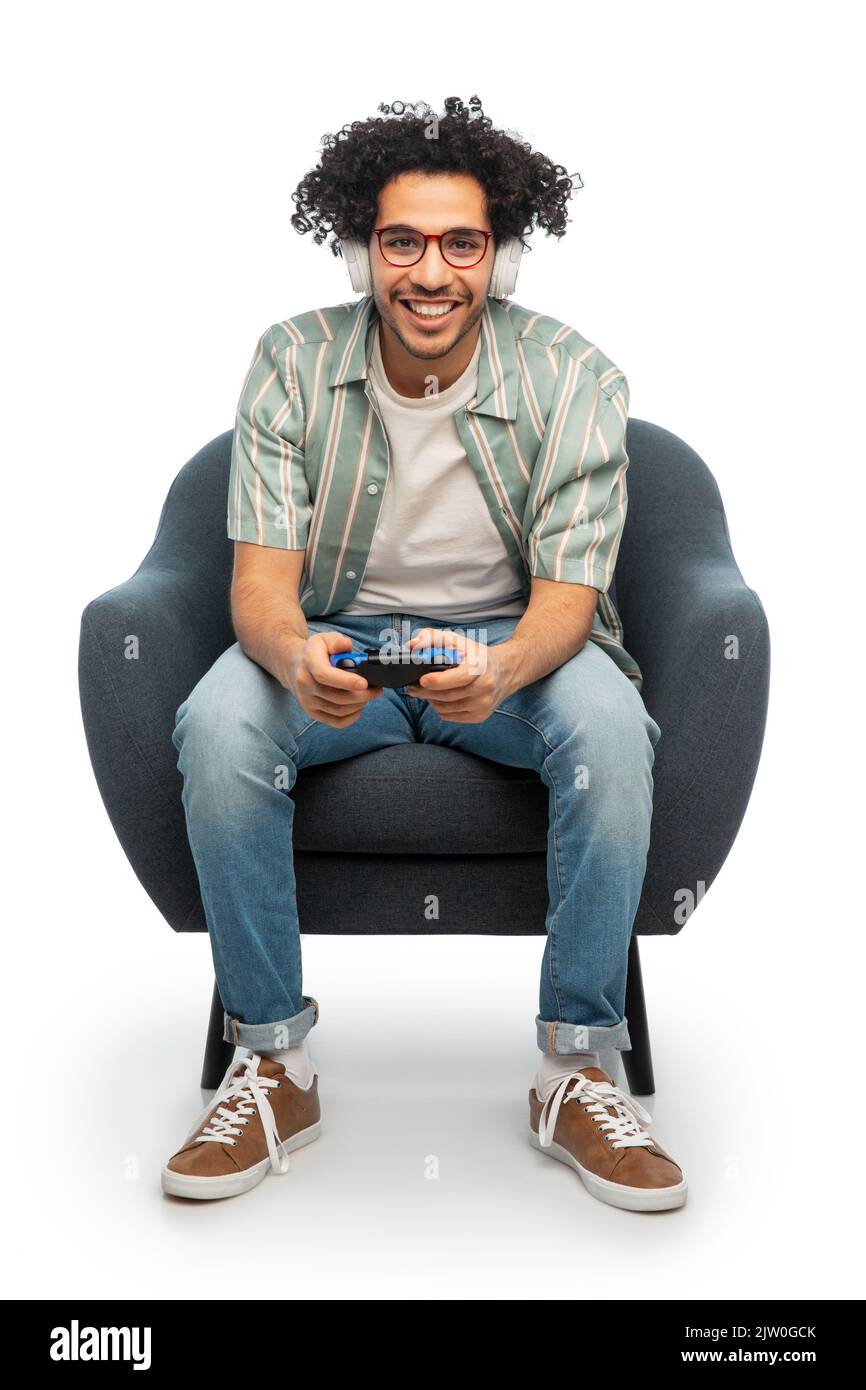 man in headphones with gamepad playing video game Stock Photo - Alamy