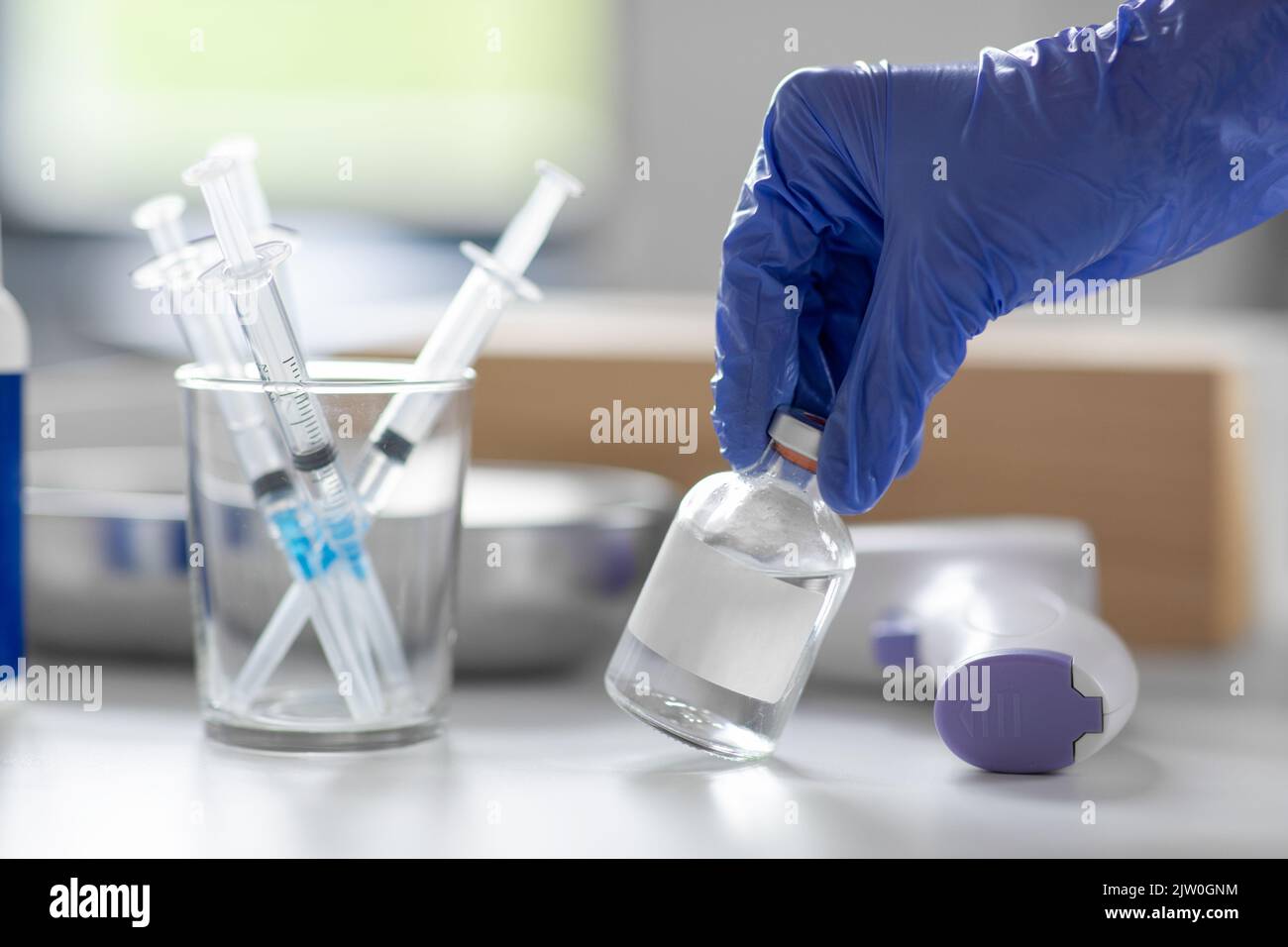 syringes and hand in glove opening medicine Stock Photo - Alamy