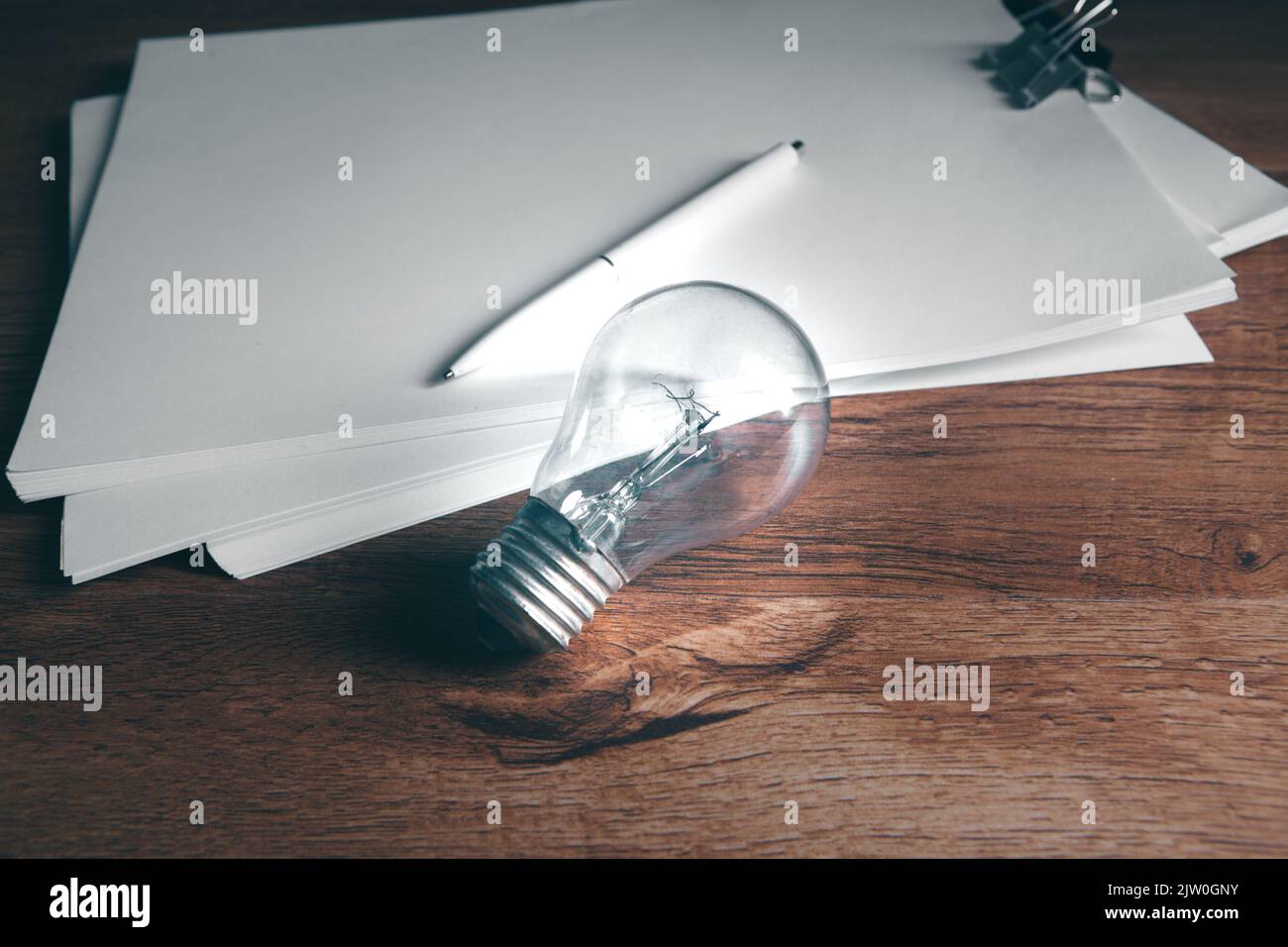 light bulb, crumpled papers and notepad on the table Stock Photo - Alamy