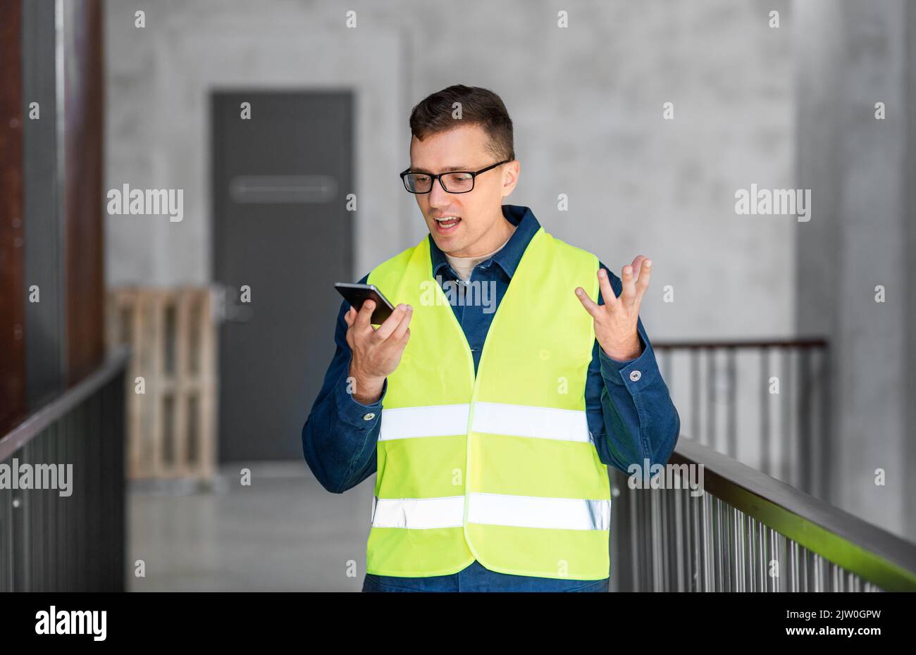 male architect calling on smartphone at office Stock Photo - Alamy