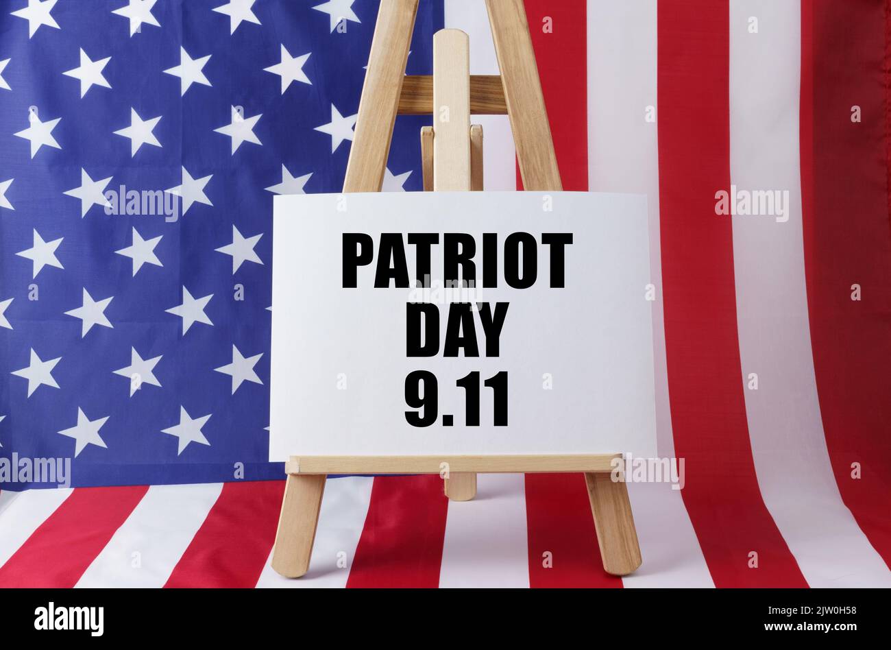 The flag of the United States has a sign that says - patriot day 911 ...