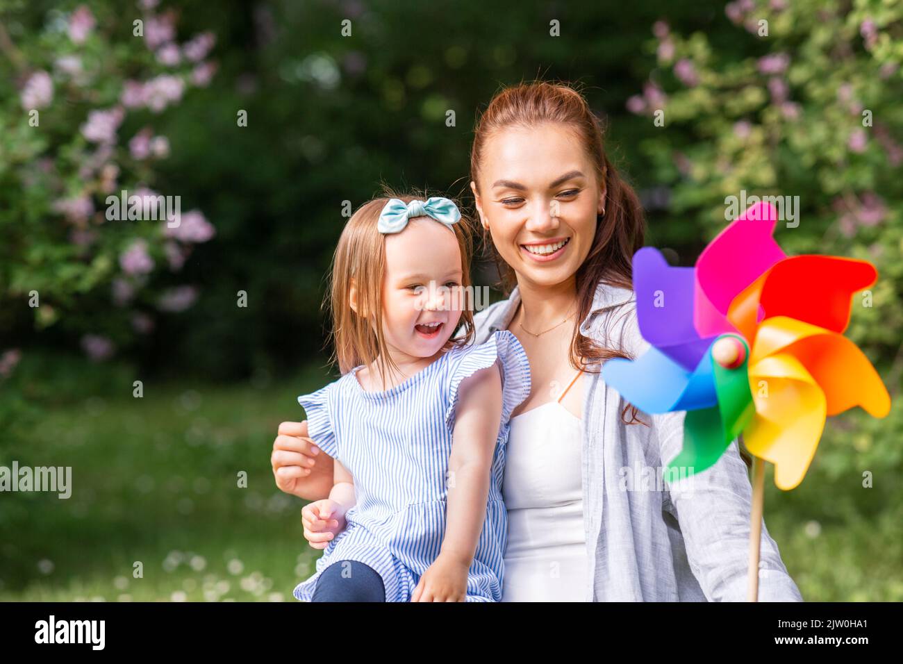happy mother and daughter with pin wheel at park Stock Photo - Alamy