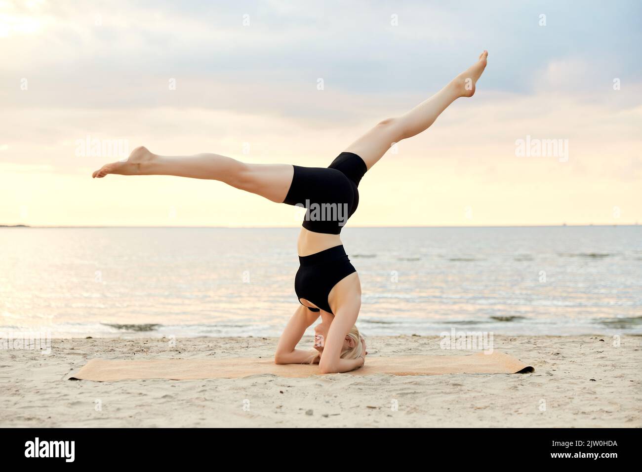Woman doing headstand hi-res stock photography and images - Alamy