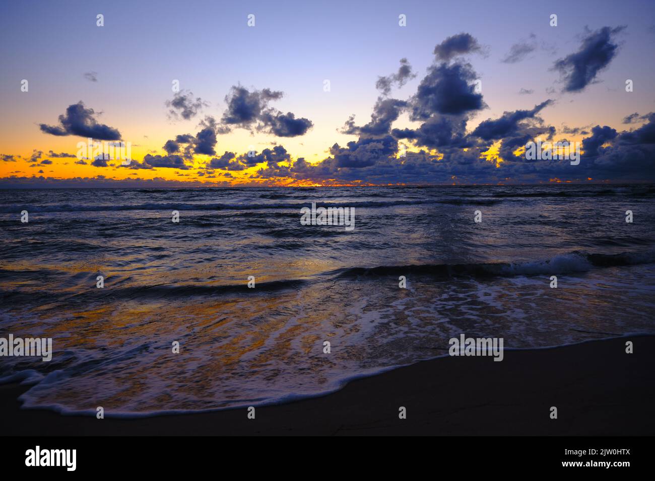 Dramatic summer sunset sky and tropical sea at dusk. Beach sand, sea ...