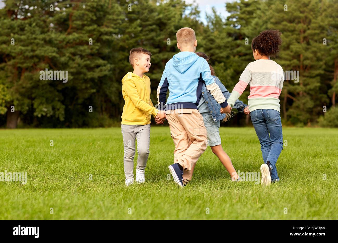happy children playing round dance at park Stock Photo - Alamy