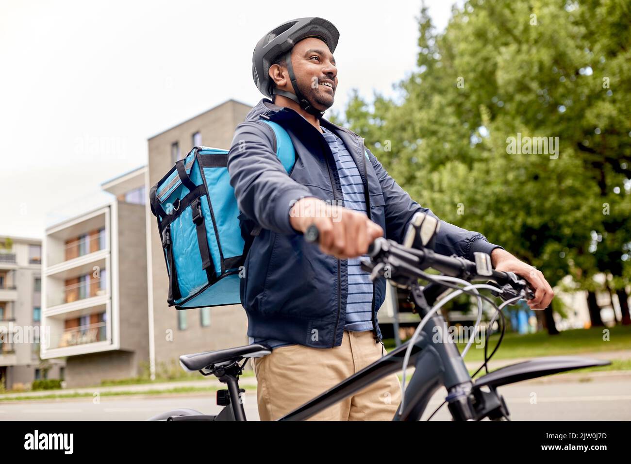indian delivery man with bag and bicycle in city Stock Photo - Alamy