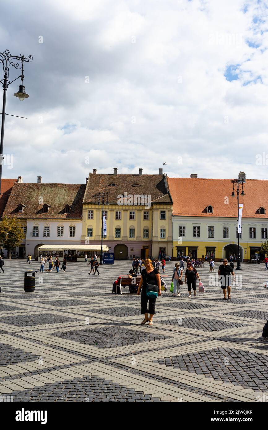 People and tourists wandering on the streets of old town Sibiu, Romania ...