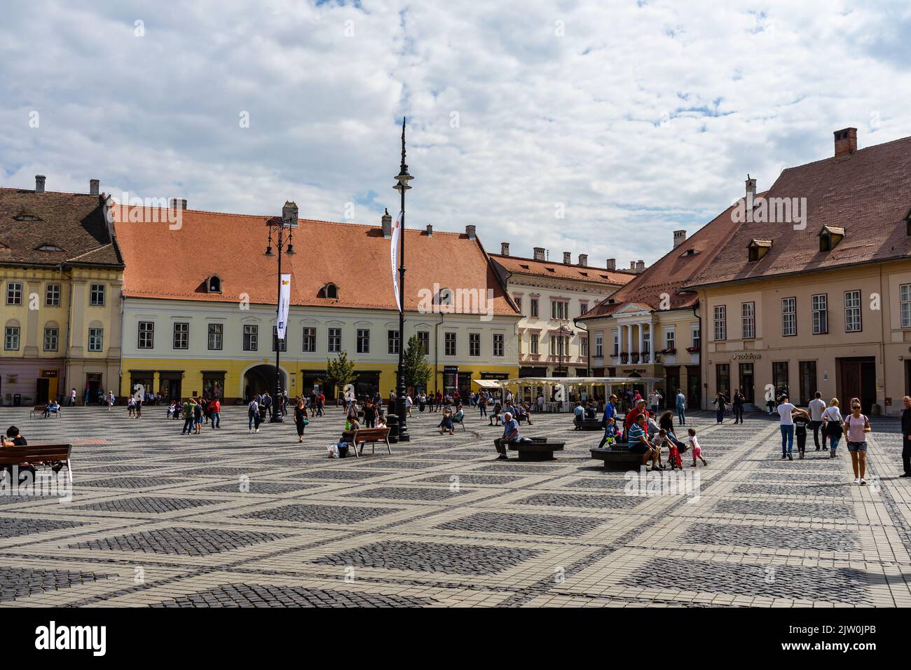 People and tourists wandering on the streets of old town Sibiu, Romania ...