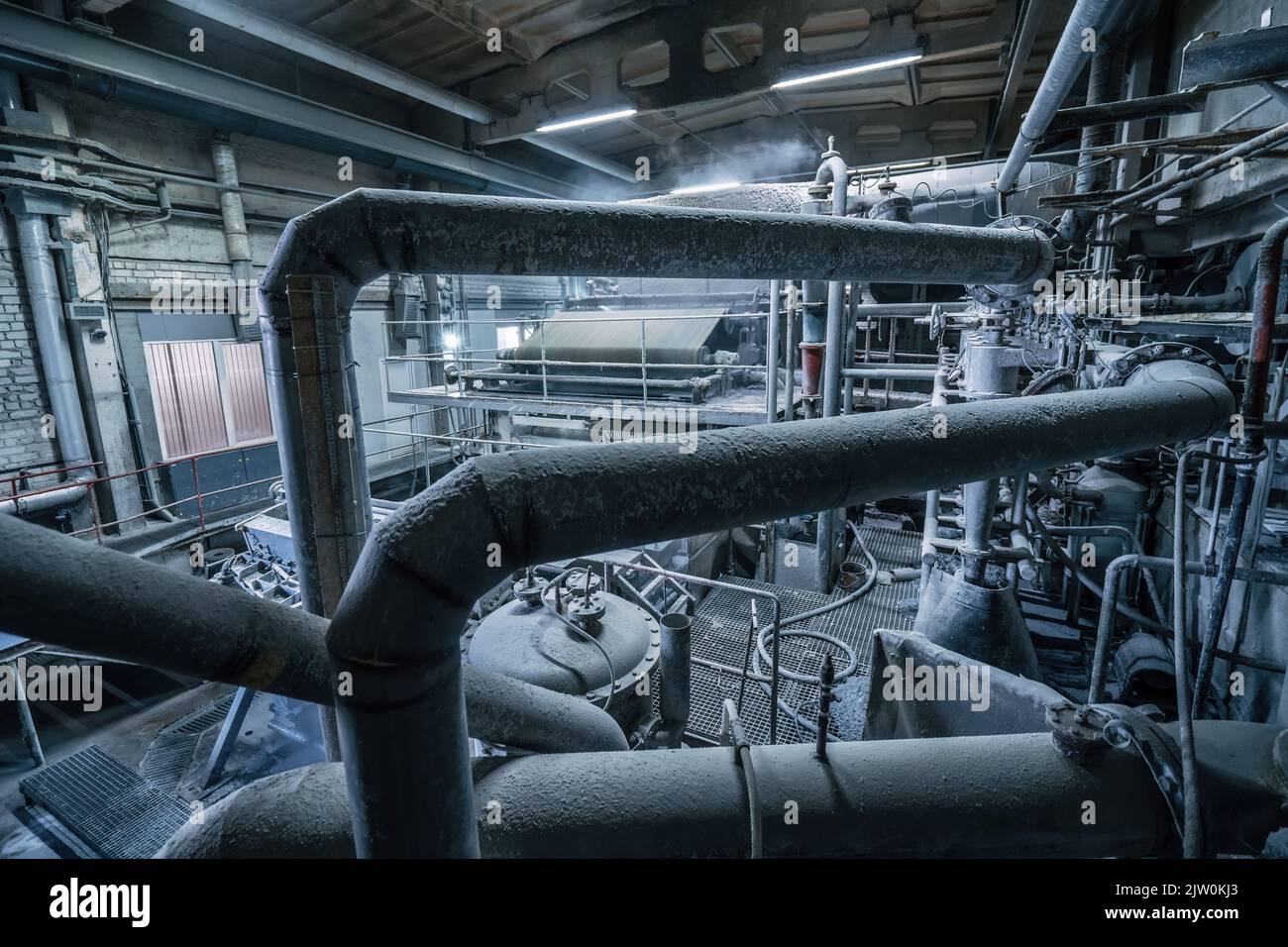 Steel pipes and tubes in waste paper recycling factory. Paper Mill ...
