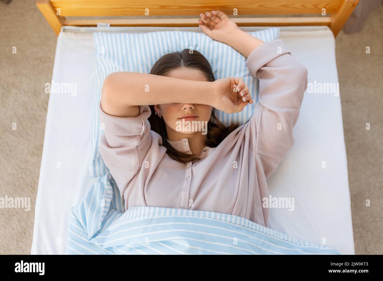 sleepy girl lying in bed at home in morning Stock Photo - Alamy
