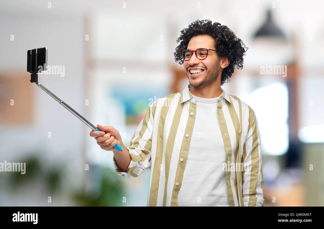 happy man taking selfie with smartphone at office Stock Photo - Alamy