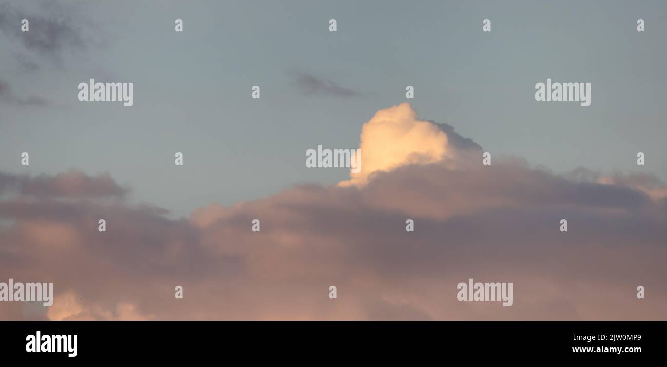 Puff Clouds in the Sky during sunset. Zoom in Stock Photo - Alamy