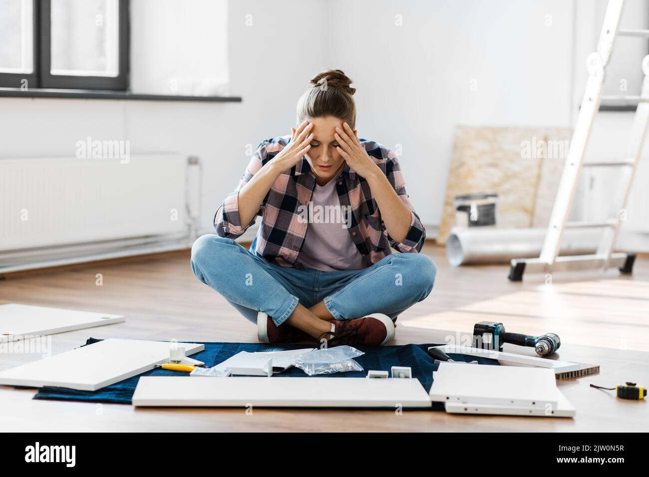 stressed woman assembling new furniture at home Stock Photo - Alamy