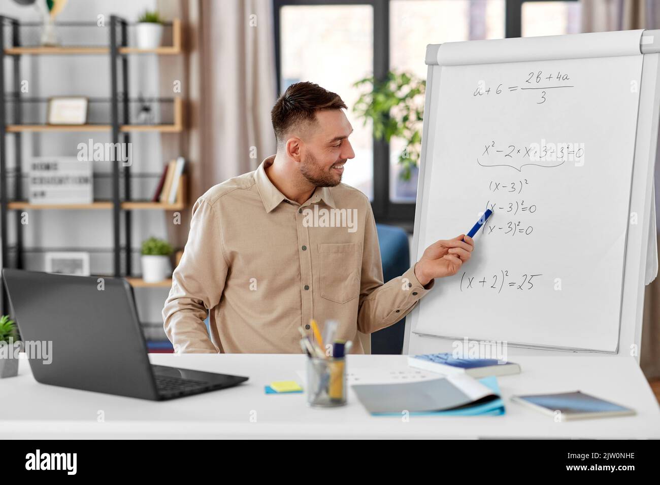 math teacher with laptop has online class at home Stock Photo - Alamy