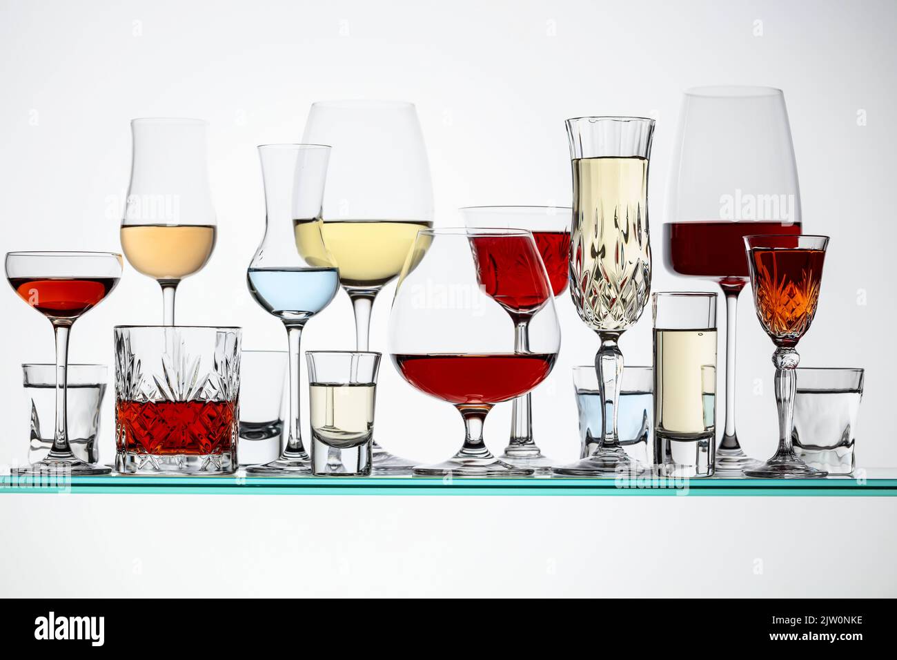 Various alcoholic drinks in the bar on glass shelves Stock Photo - Alamy