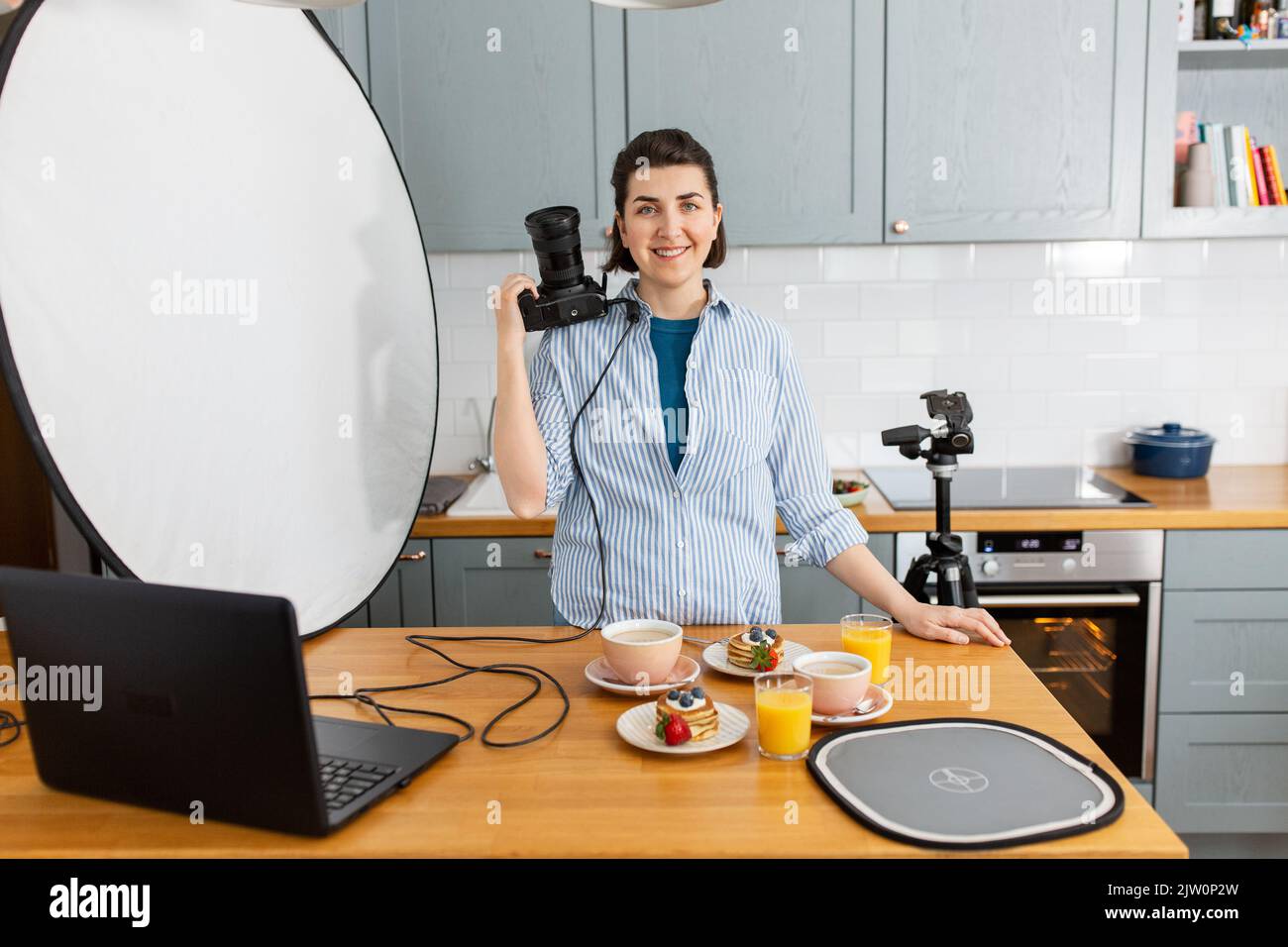 food photographer with camera working in kitchen Stock Photo - Alamy