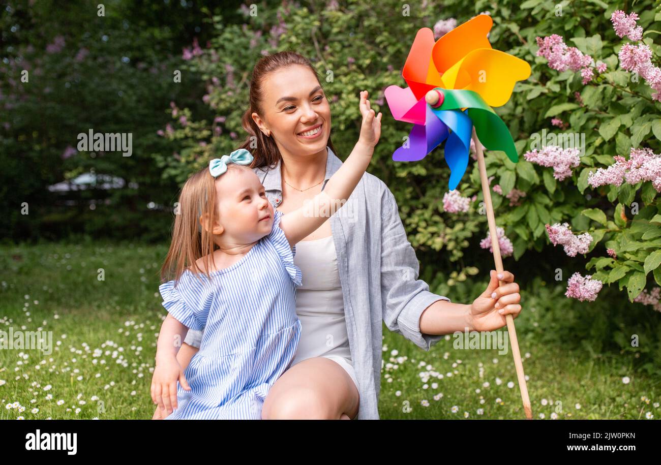 happy mother and daughter with pin wheel at park Stock Photo - Alamy