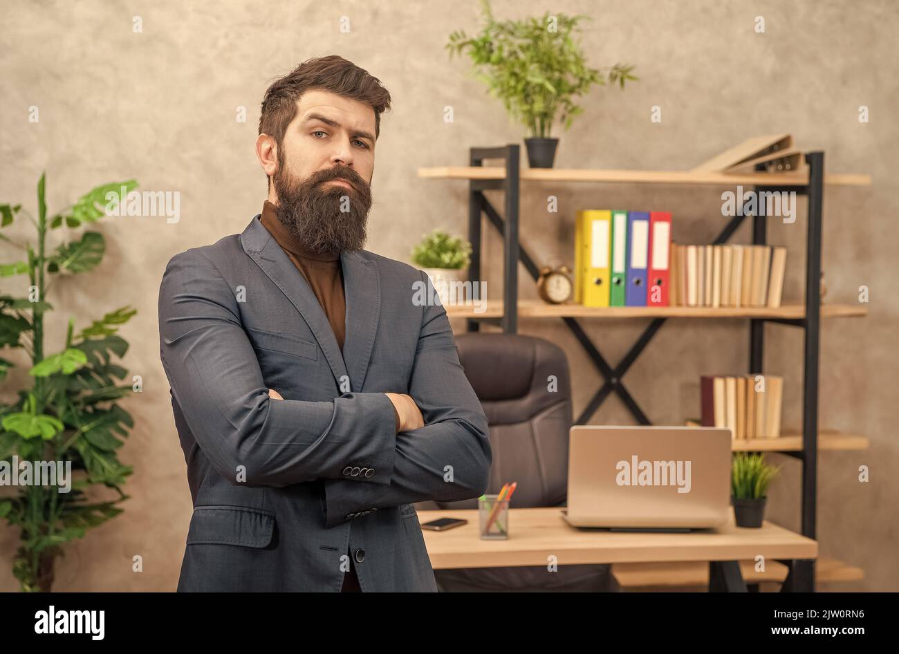 confident brutal lawyer in businesslike suit at the office with copy ...