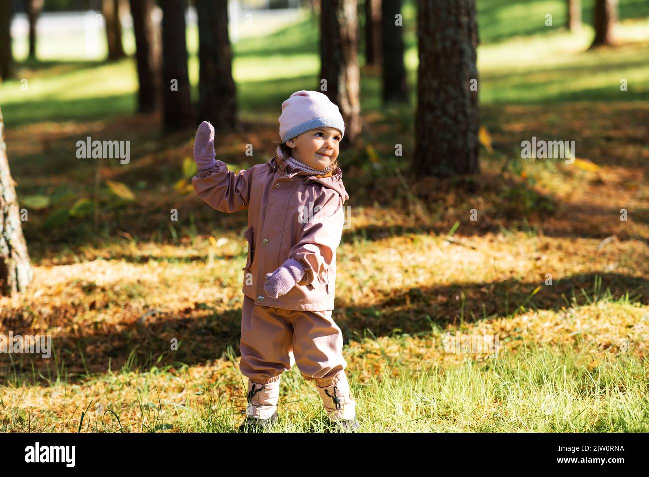 happy little baby girl walking in autumn park Stock Photo - Alamy