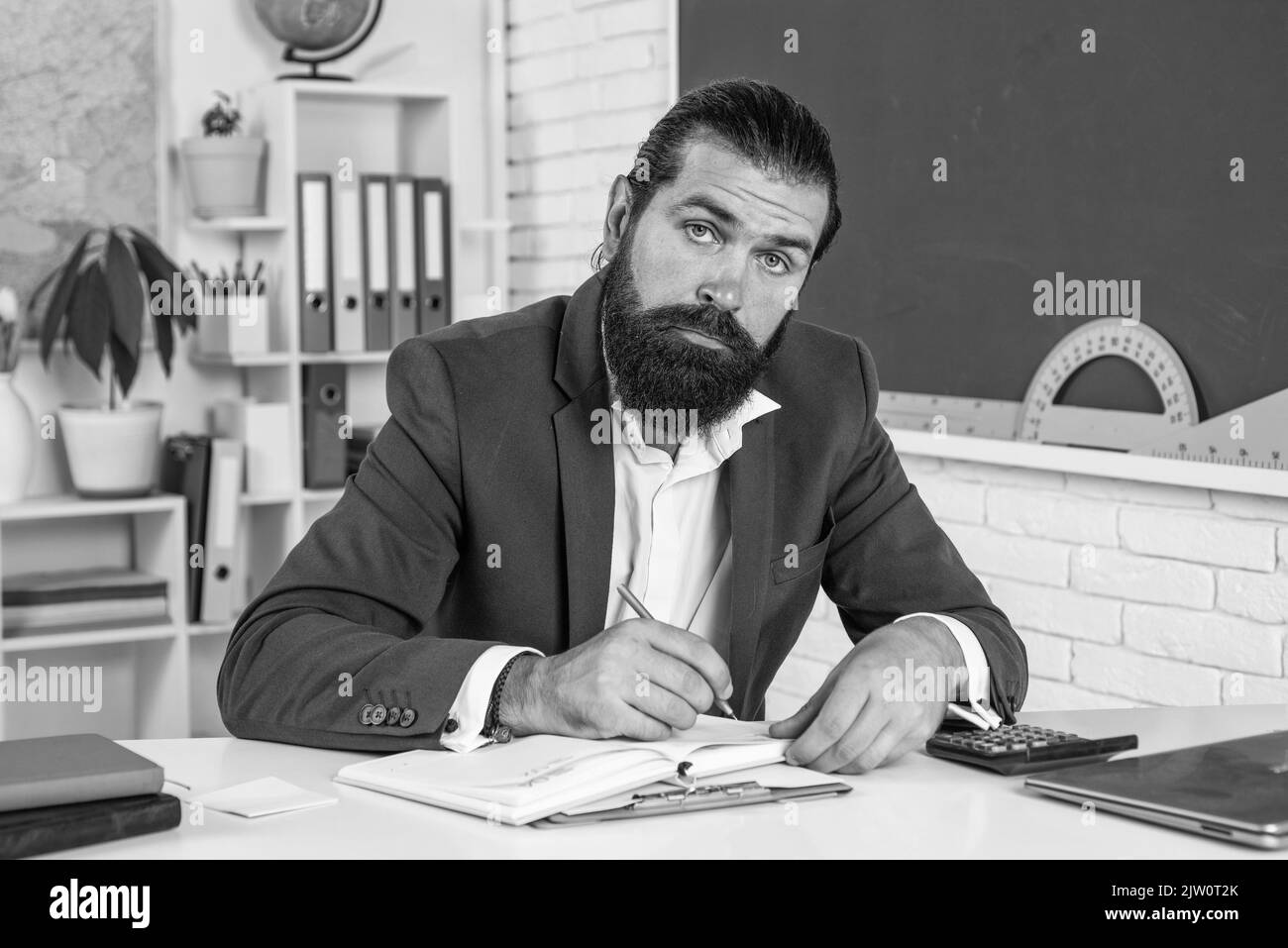 too much work. informal education. male student sit in classroom while ...