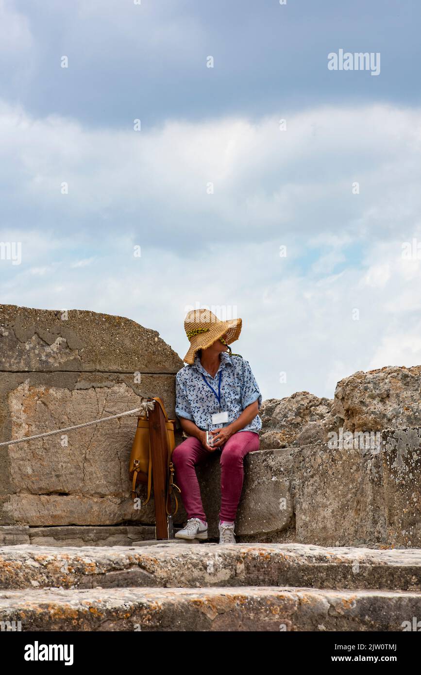 tourist guide at the ancient greek palace of knossos taking a break ...