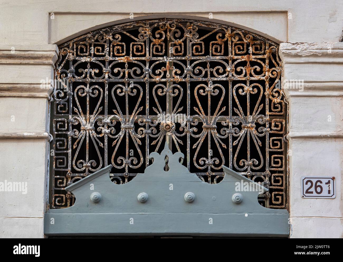 iron ornate grille on old weather beaten greek window for security ...