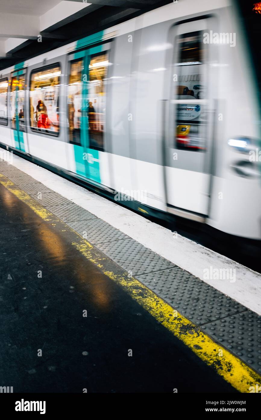 A vertical of an arriving metro train in motion Stock Photo - Alamy