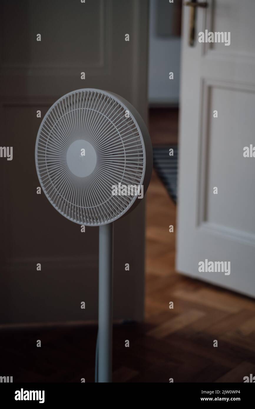 A white working electric floor standing fan at home Stock Photo - Alamy