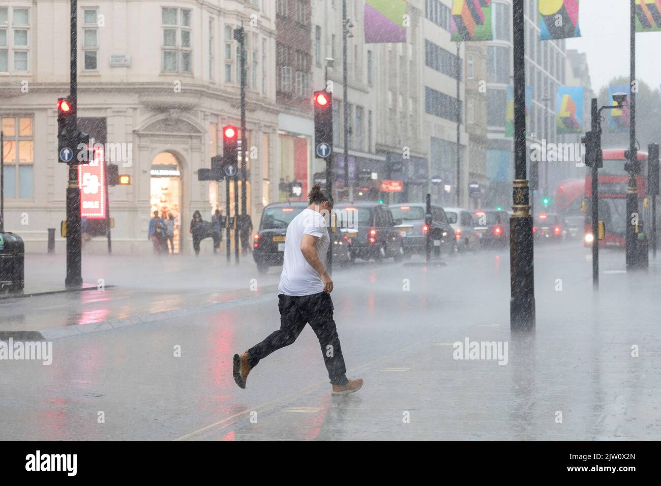 Amber rain catches Londoners this afternoon at Oxford Street. Image ...