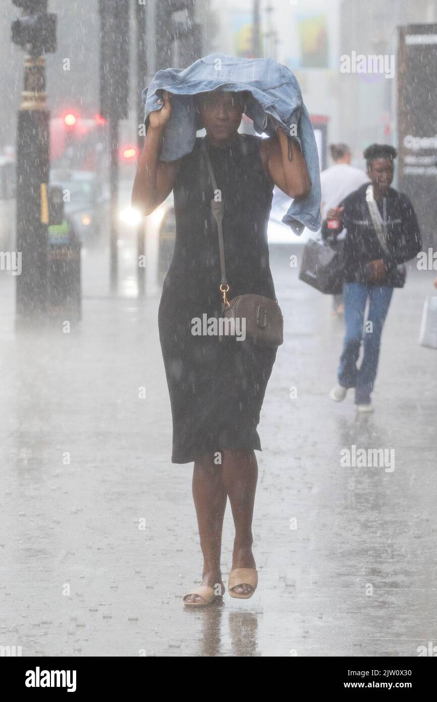 Amber rain catches Londoners this afternoon at Oxford Street. Image ...