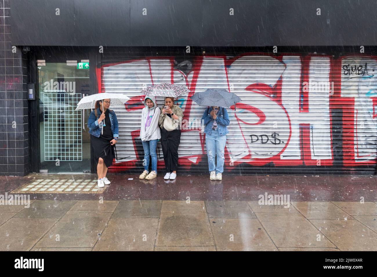 Amber rain catches Londoners this afternoon at Oxford Street. Image ...