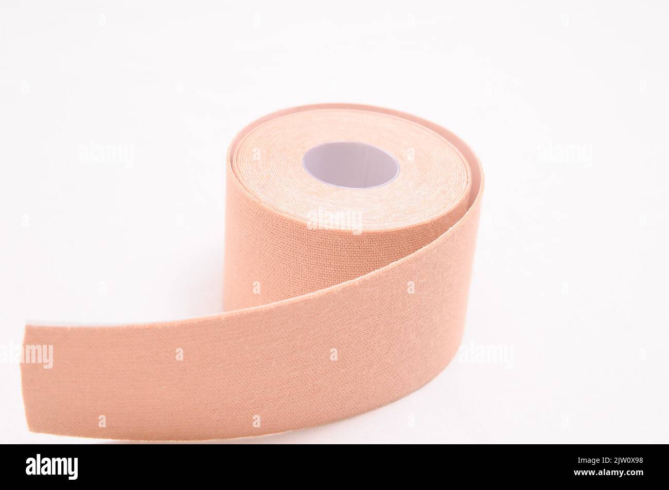 A shot of a rose pink cloth wrapped on a roll with one side free on a ...