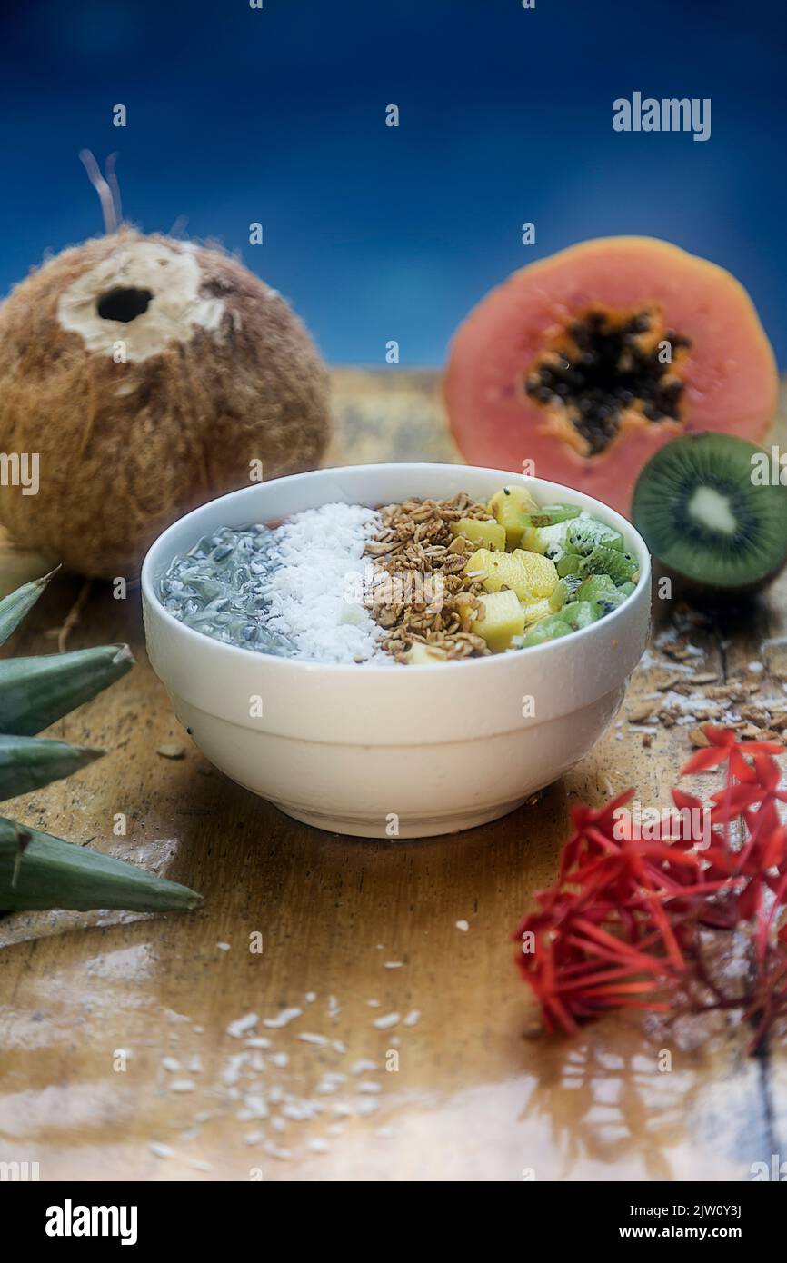 Poke bowl with passion fruit, coconut, dried fruits, pineapple and kiwi ...