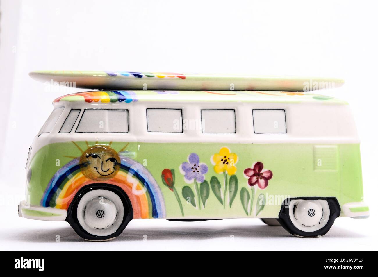 A small replica Volkswagen van decor with art on the sides and a ...