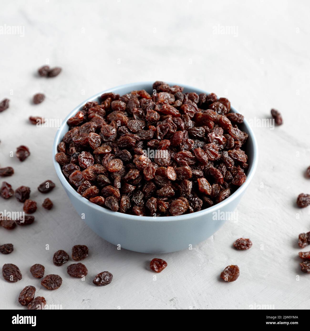 Dried Brown Raisins in a Bowl, side view Stock Photo - Alamy