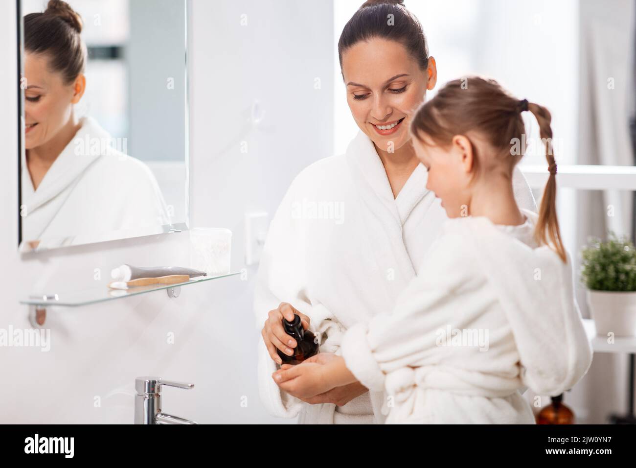 mother and daughter with liquid soap in bathroom Stock Photo - Alamy