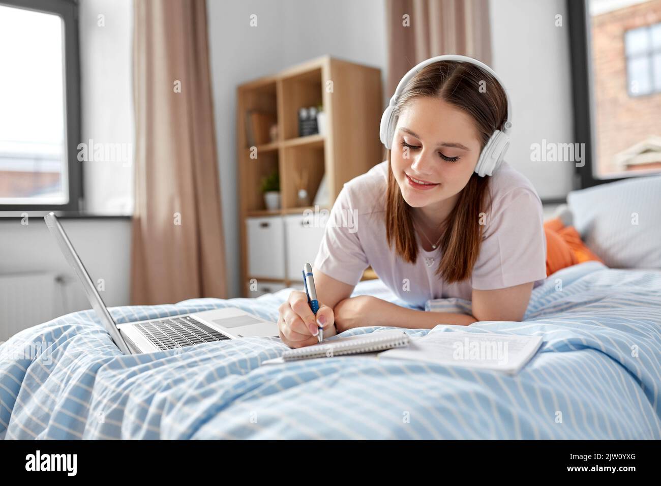 happy student girl in headphones learning at home Stock Photo - Alamy
