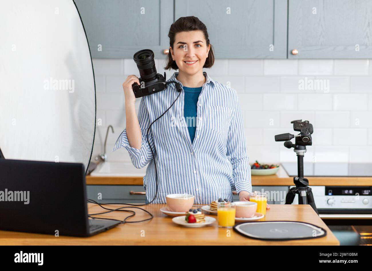 food photographer with camera working in kitchen Stock Photo - Alamy