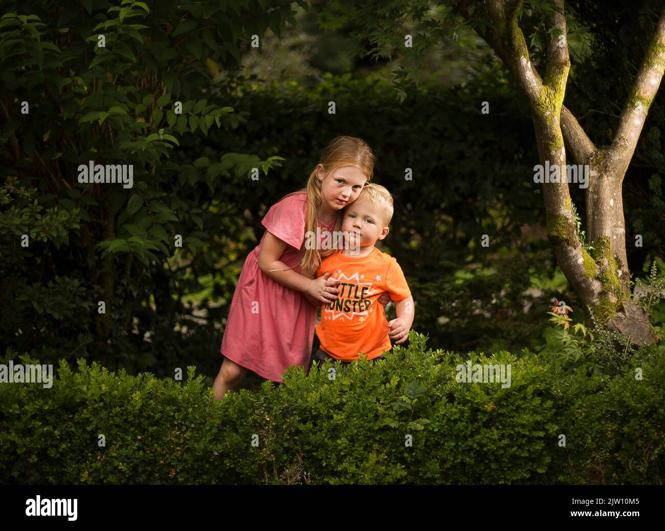 Young brother and sister posing outdoors without smiling Stock Photo ...