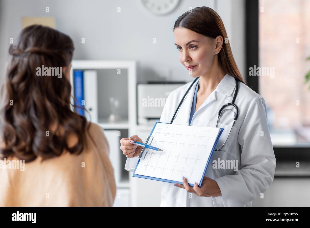 doctor showing cardiogram to woman at hospital Stock Photo - Alamy