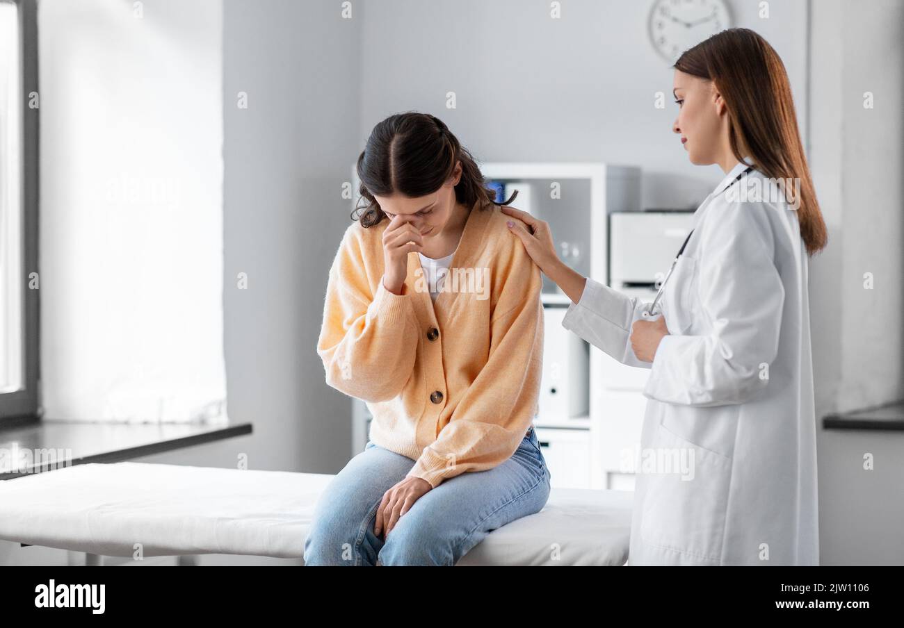 female doctor comforting sad woman at hospital Stock Photo - Alamy