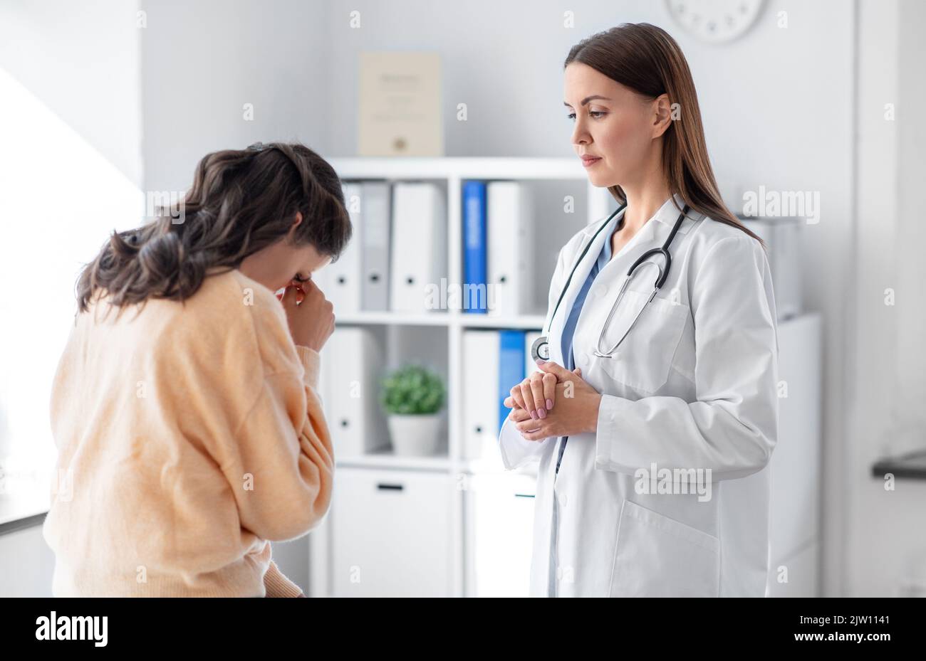 Woman sad talking doctor hi-res stock photography and images - Alamy