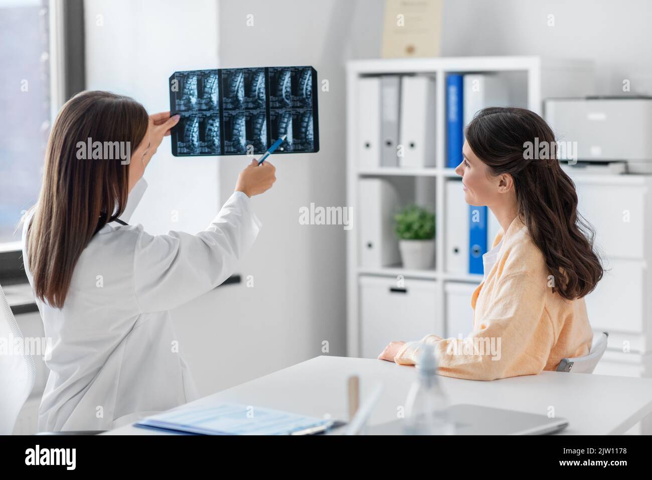 doctor showing x-ray image to woman at hospital Stock Photo - Alamy