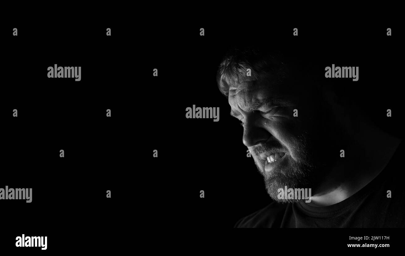 Crying Caucasian male looking downwards Stock Photo - Alamy