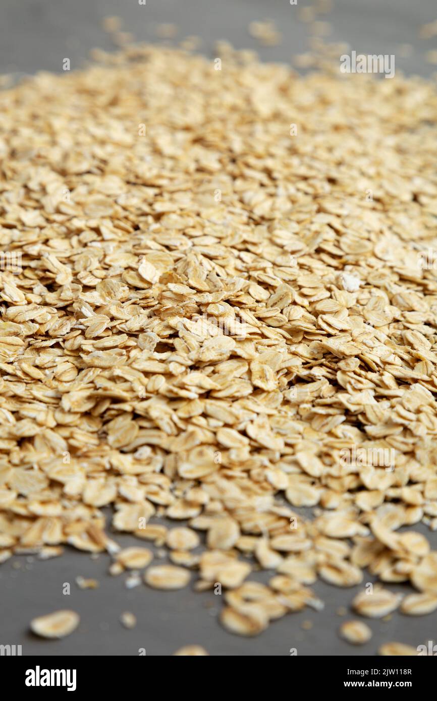 Dry Organic Rolled Oats on a gray surface, side view Stock Photo - Alamy