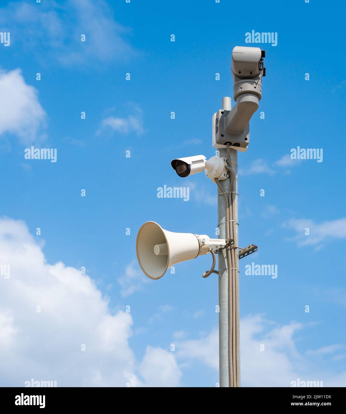 Modern CCTV cameras and alarm siren mounted on a pole Stock Photo - Alamy